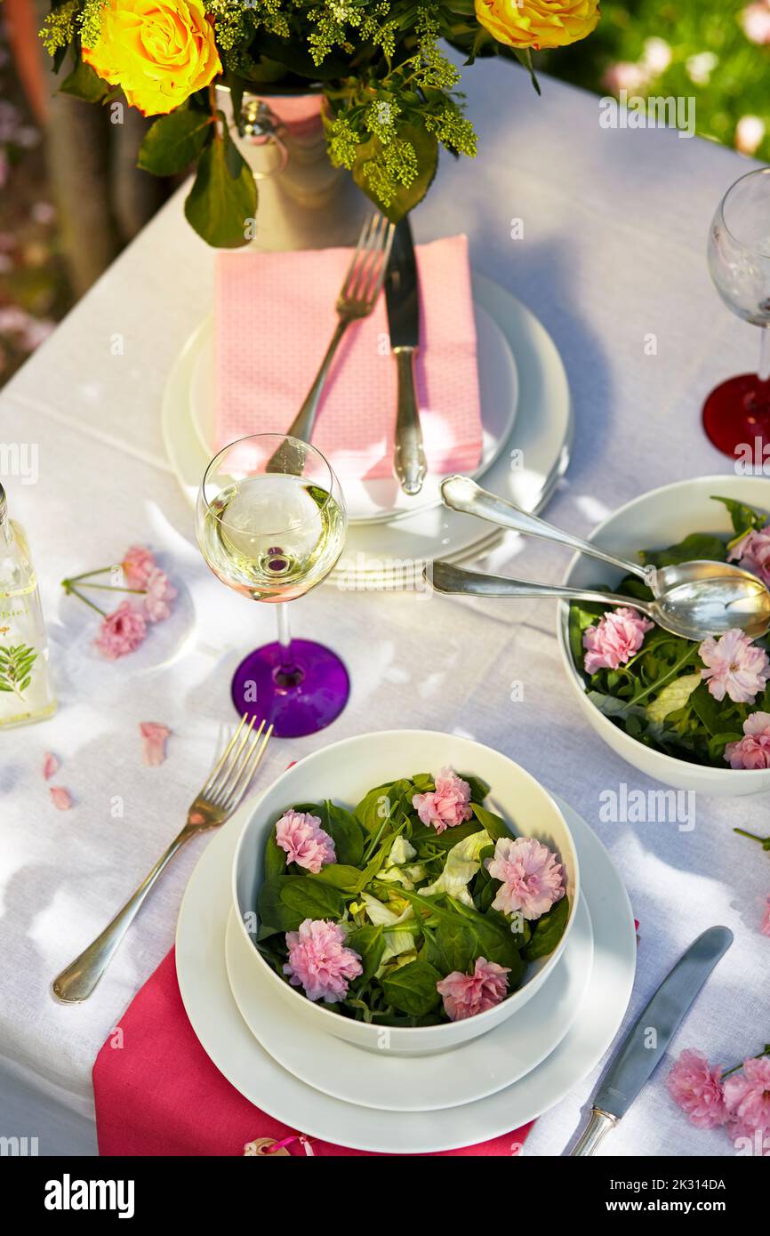 Elegant spring decorated table with edible flowers Stock Photo - Alamy