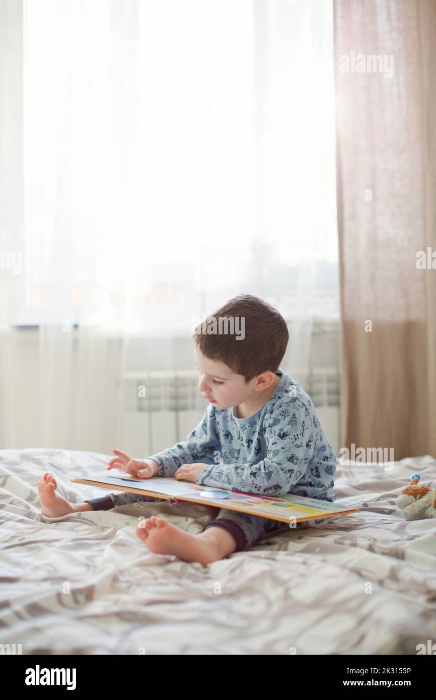 Boy reading picture book hi-res stock photography and images - Alamy