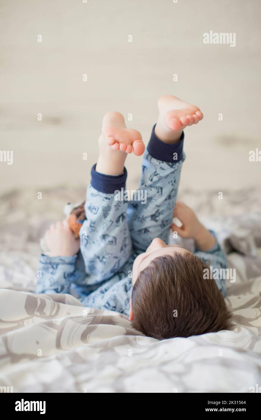 Playful boy playing on bed Stock Photo - Alamy