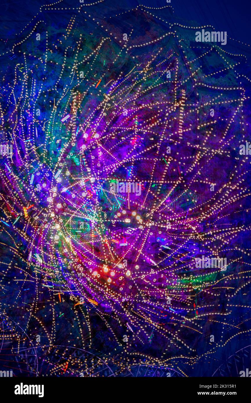 Colorful lights of spinning amusement park ride Stock Photo - Alamy