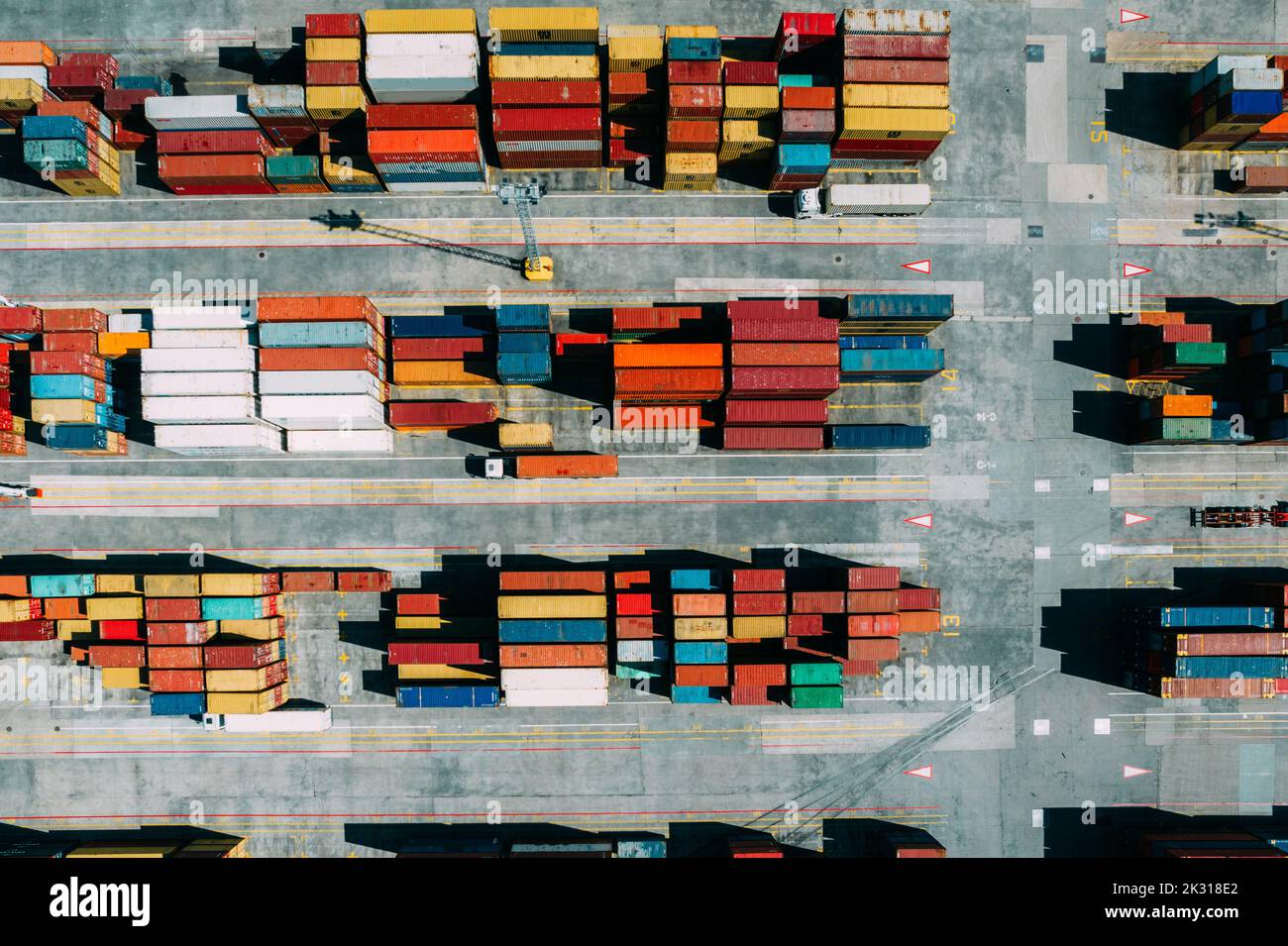 Aerial drone top down view of containers spread across a busy port ...
