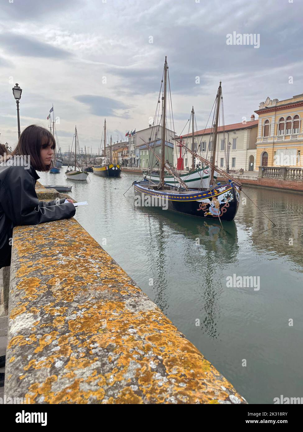 Cesenatico, Italy. Tourists on the quay looking at the display of ...