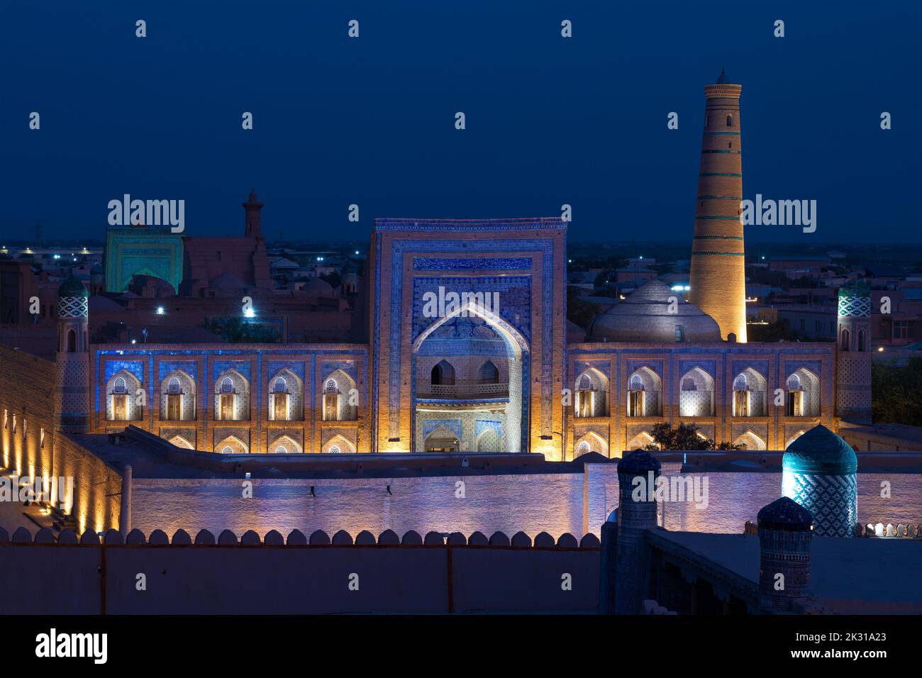 The old madrasah of Muhammad Rahim Khan in the backlight in the urban ...