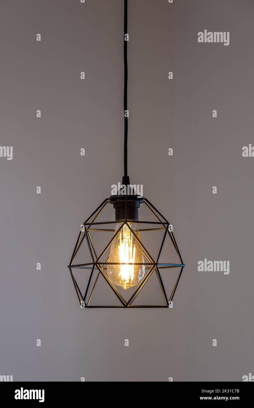 A black pendant lamp shade hanging on the ceiling, vertical shot Stock ...