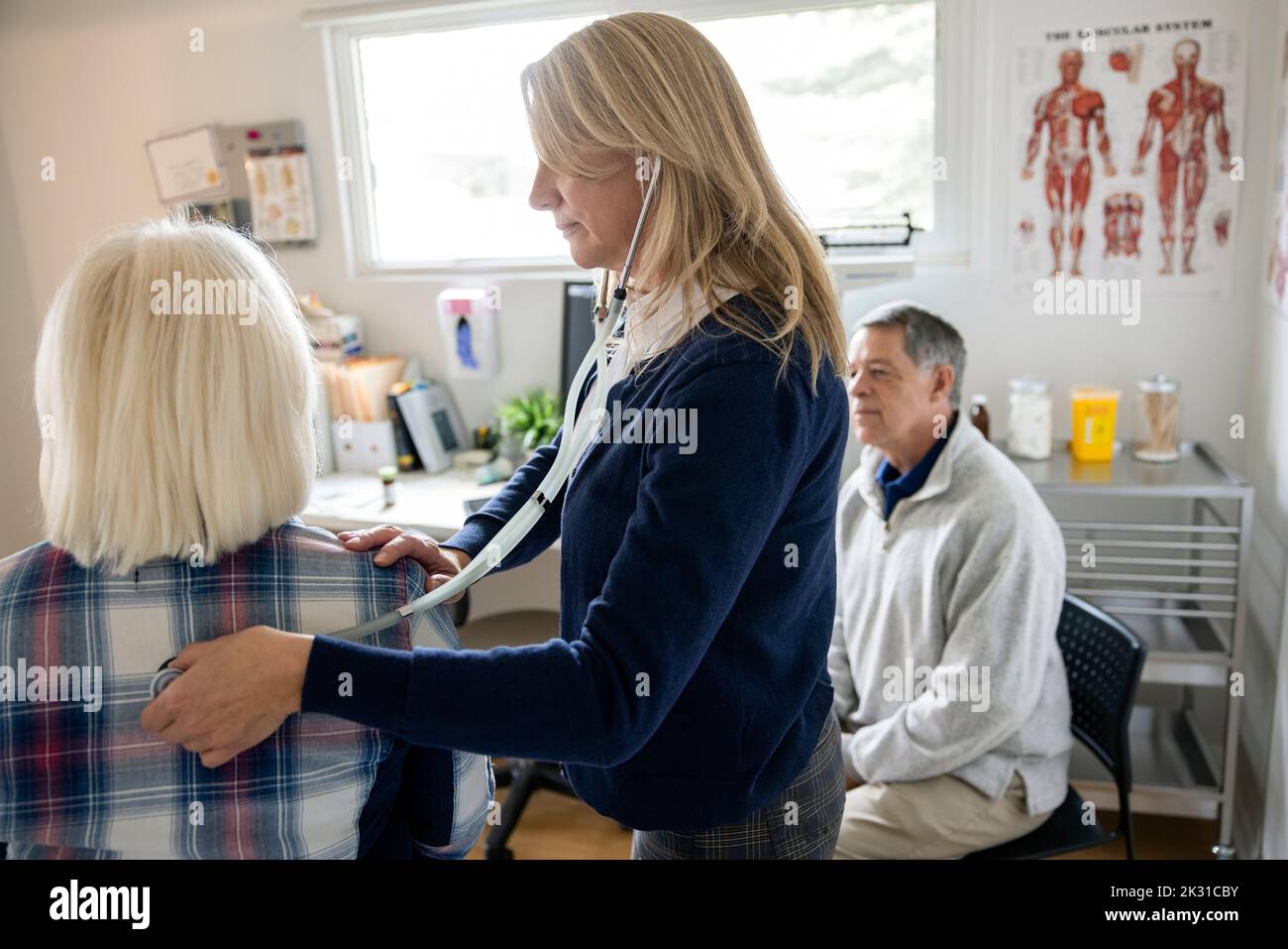Doctor examining patient with stethoscope hi-res stock photography and ...