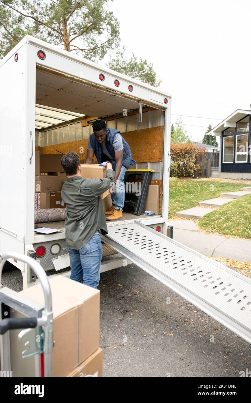 Worker unloading boxes hi-res stock photography and images - Alamy