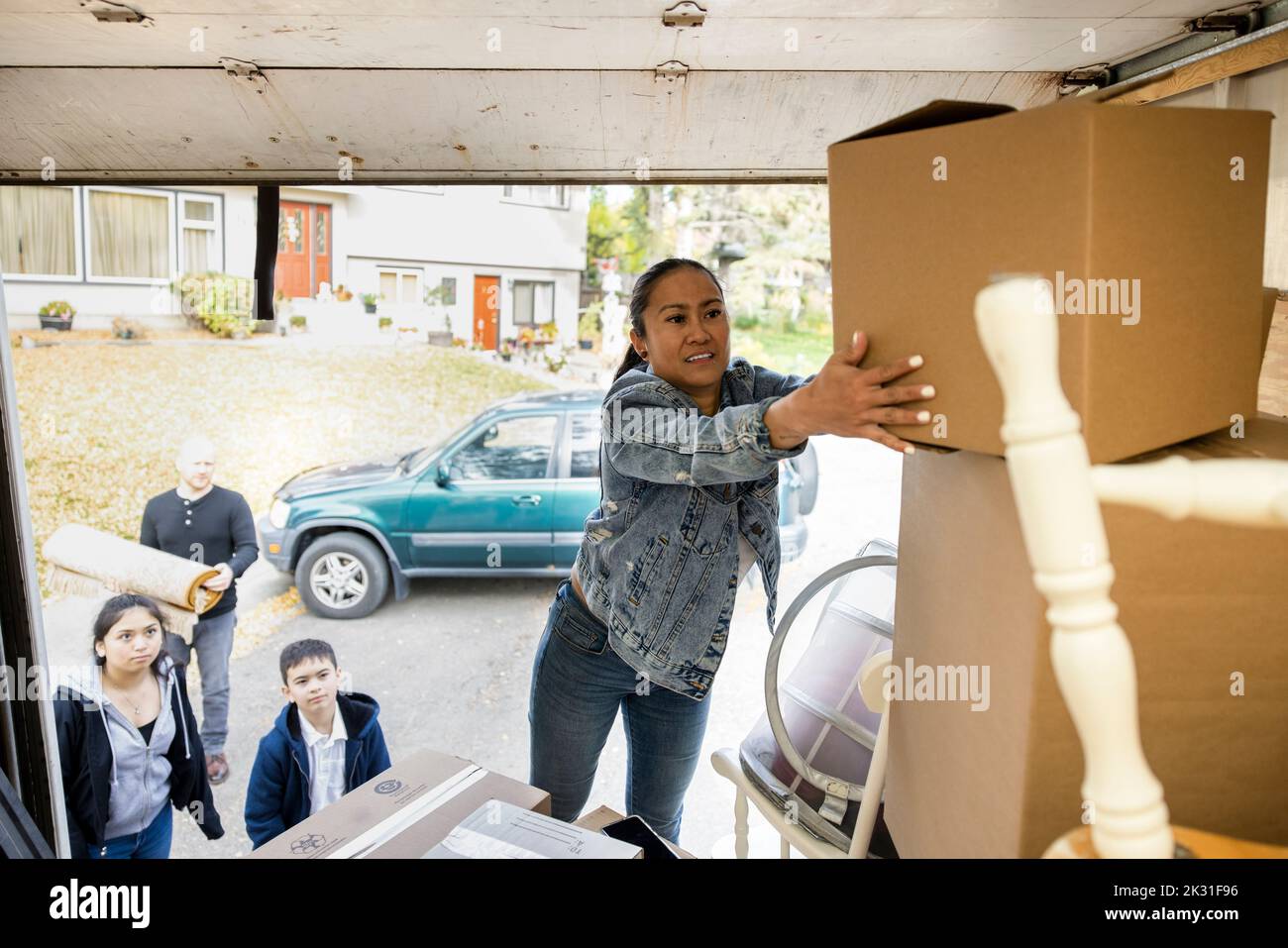 Family moving boxes teen hi-res stock photography and images - Alamy
