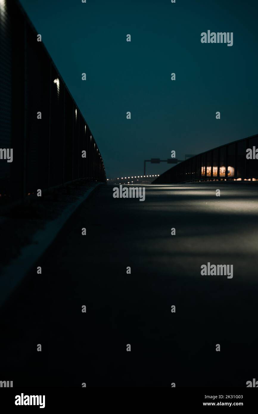 A vertical ground level shot of a bridge at night Stock Photo - Alamy