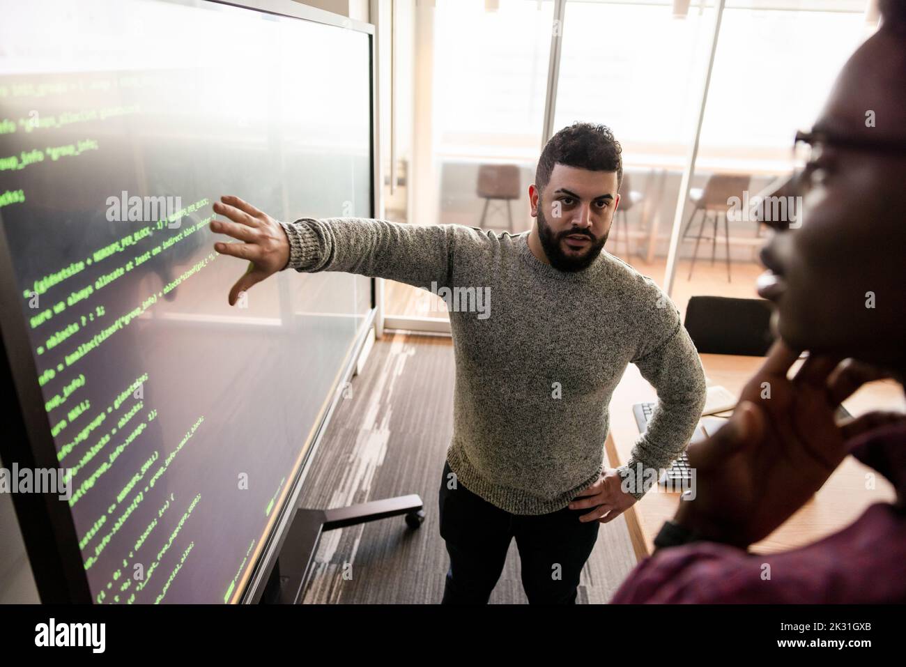 Computer Programmers At Projection Screen In Conference Room Stock 