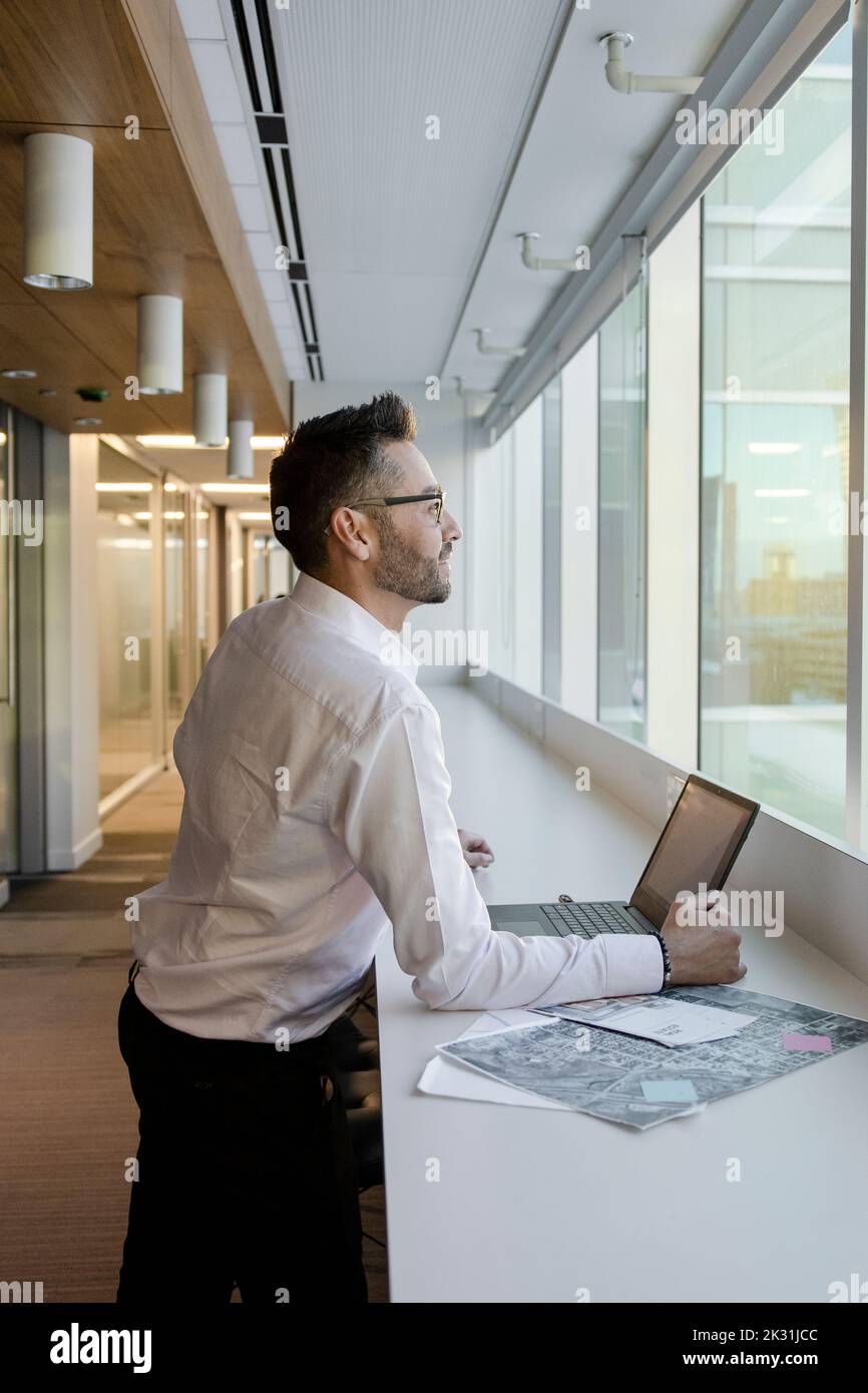Person looking out of office window hi-res stock photography and images ...