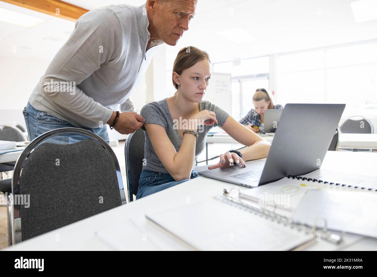 High school teacher and helping student hi-res stock photography and ...