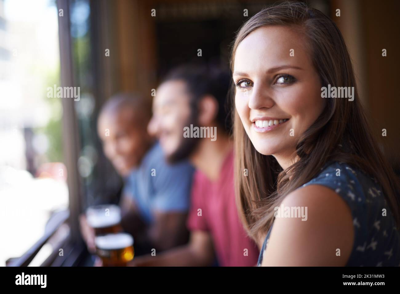 Having some drinks in the bar. A cropped shot of young friends having ...