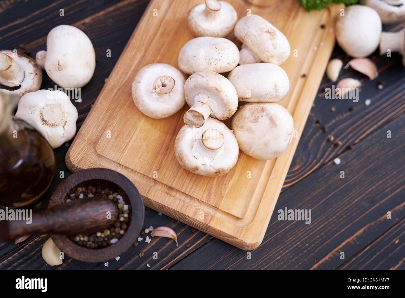 raw champignon mushrooms on wooden cutting board Stock Photo - Alamy