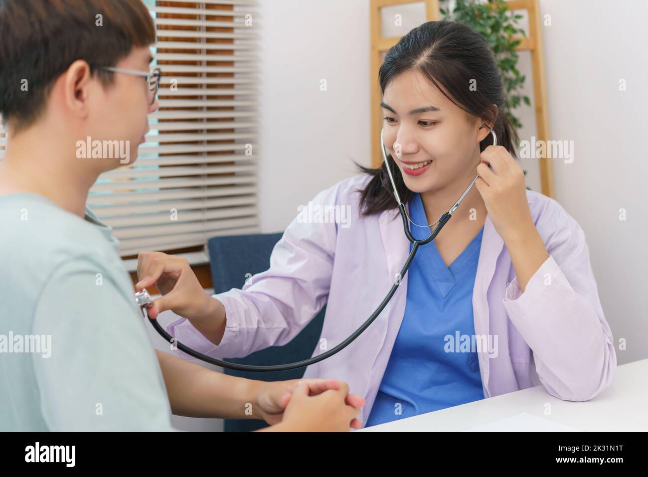 Healthcare concept, Female doctor using stethoscope with patient to ...