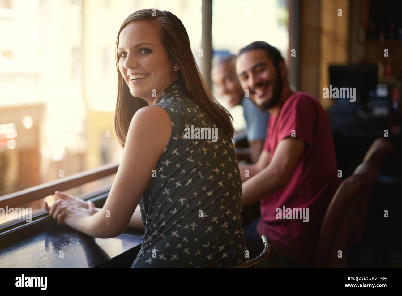 Were ready for the weekend. Portrait of a smiling young woman in a bar ...