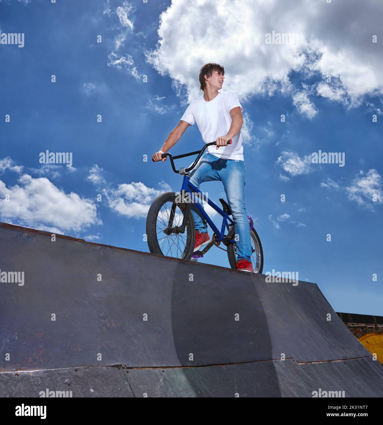 Practicing for the x games. a teenage boy riding a bmx at a skatepark ...