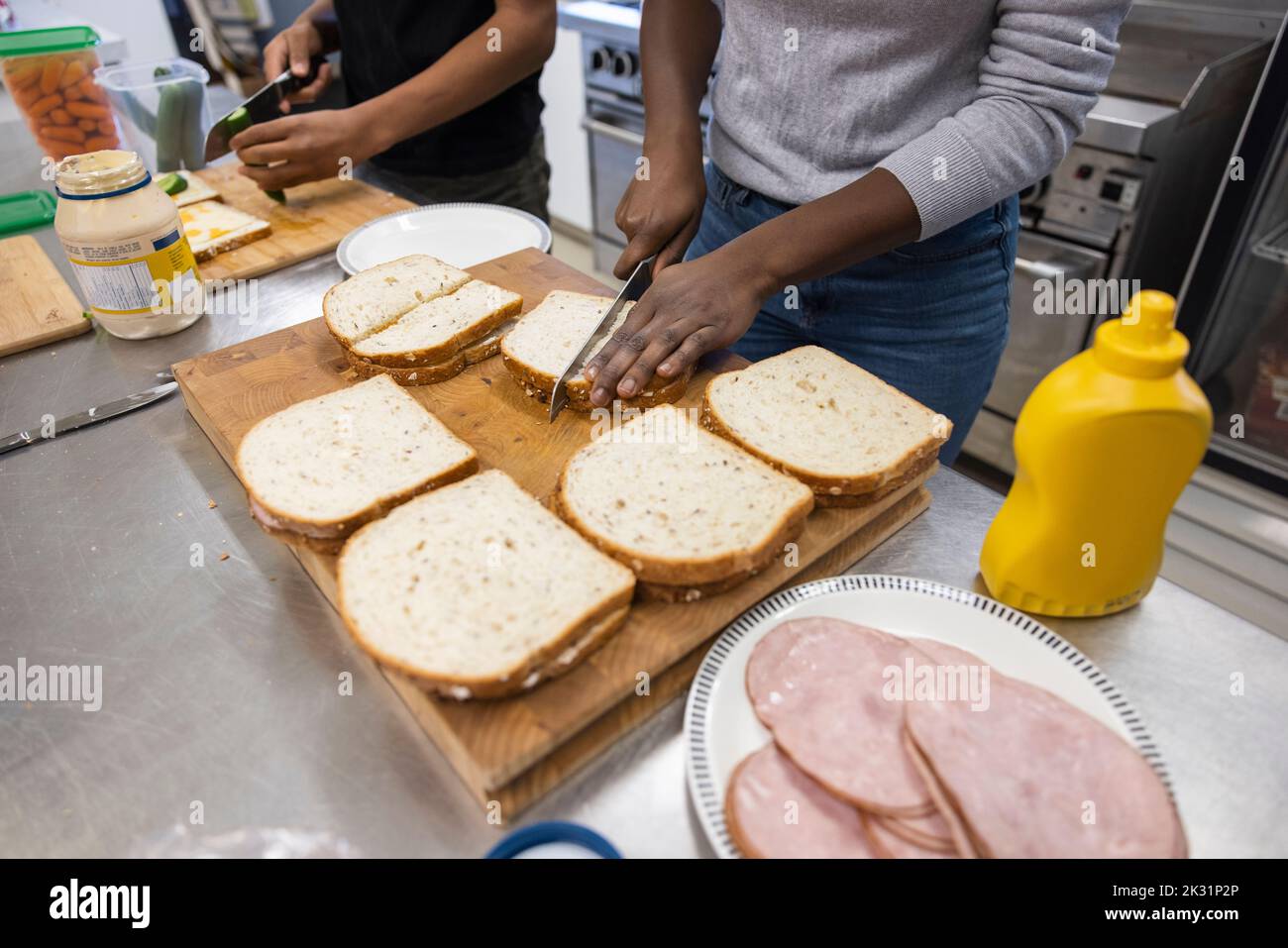 Woman cutting sandwiches in kitchen hi-res stock photography and images ...