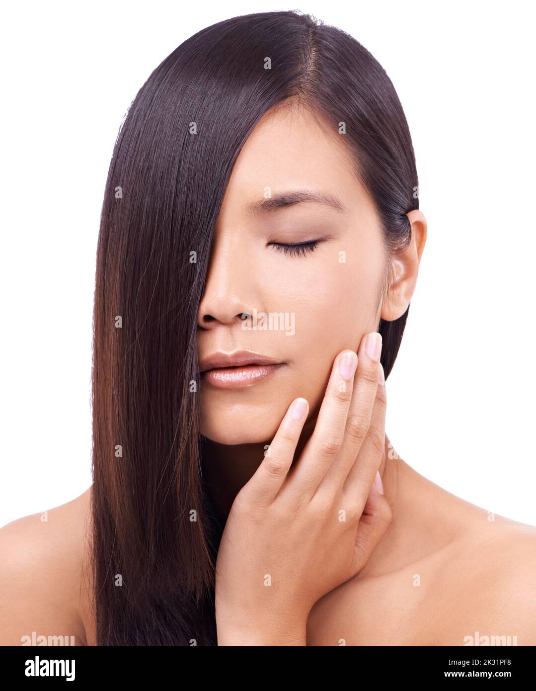 Gorgeous dark locks. a beautiful young oriental woman against a white ...