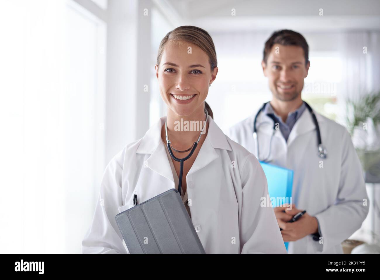 Partners in health. Portrait of two young doctors standing in a ...