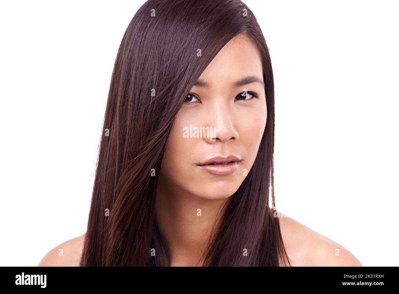 Oriental charm. a beautiful young oriental woman against a white ...