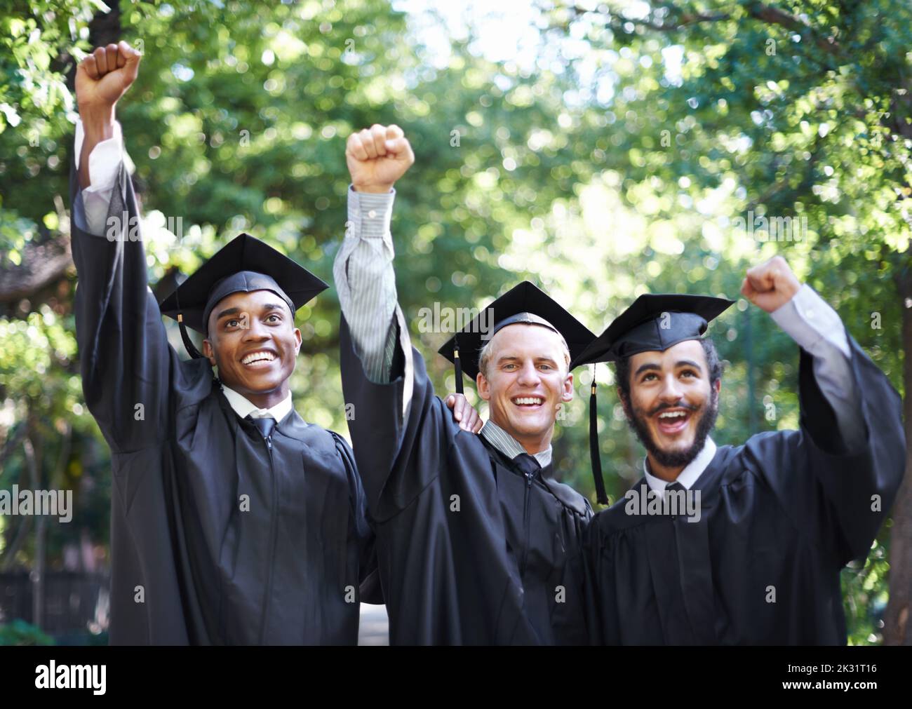 Equipped to follow their dreams. A group of happy male students ...