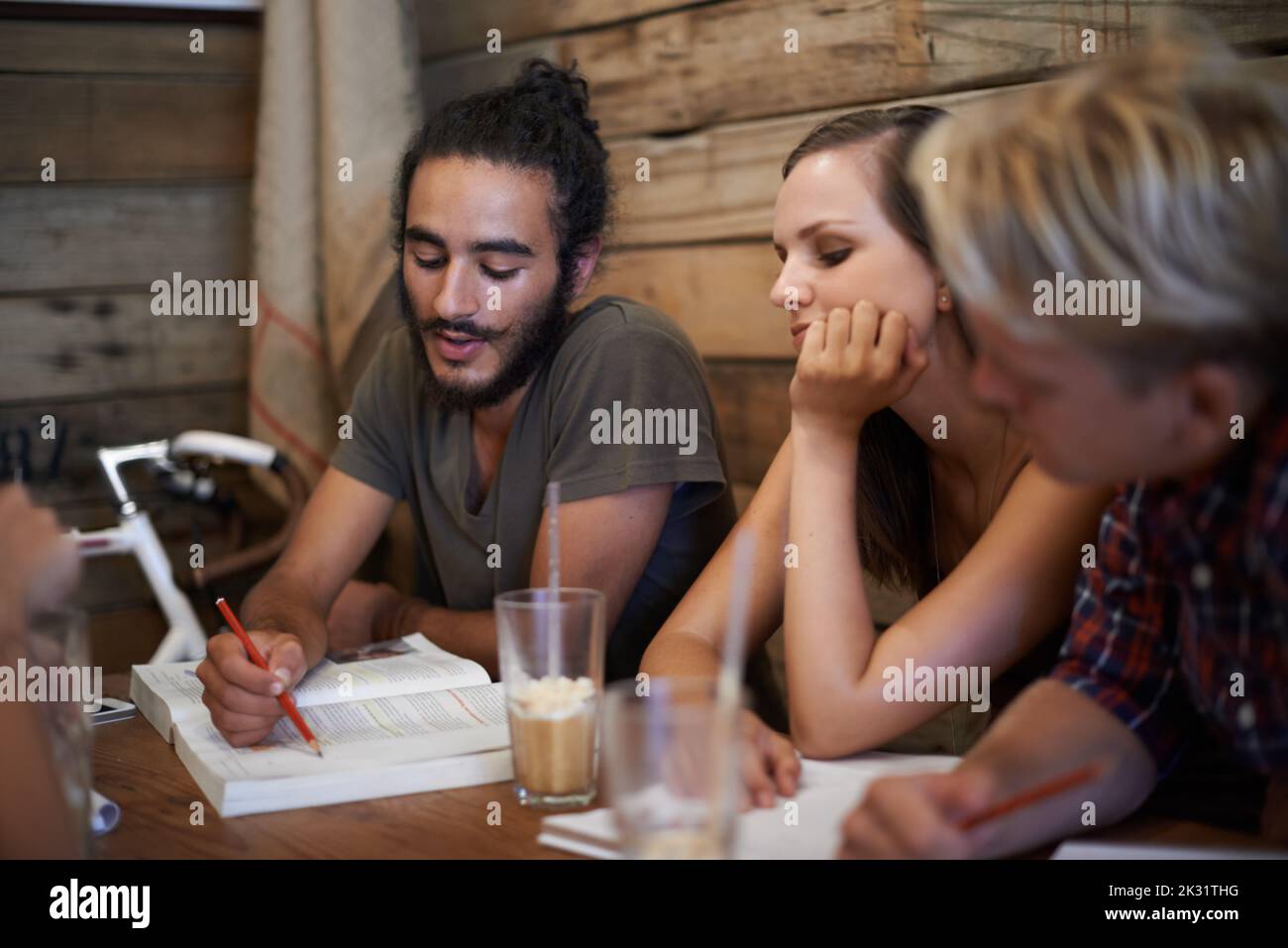 Coffee shop cram session. Cropped shot a group of friends studying ...