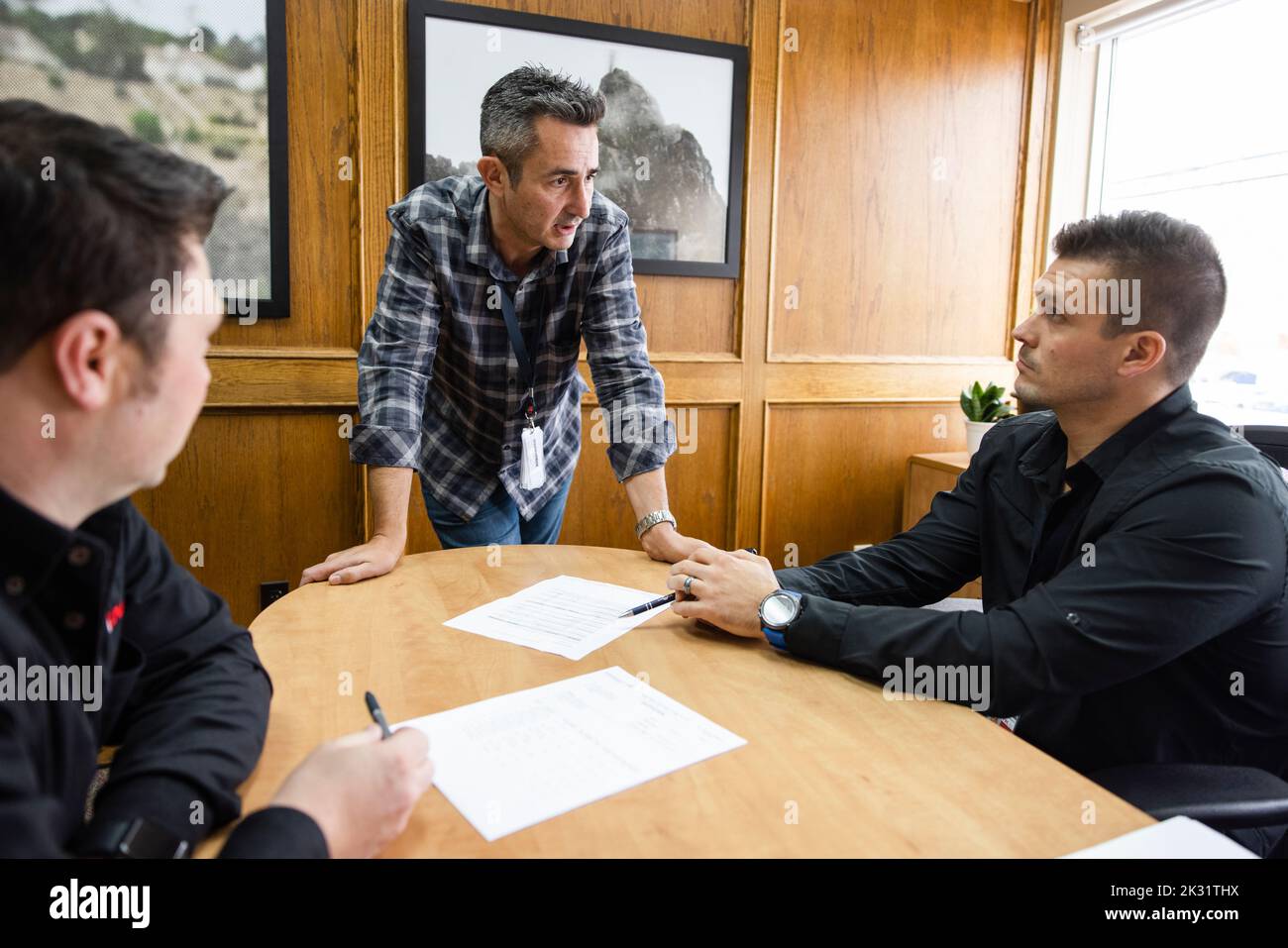 Three men having meeting in office Stock Photo - Alamy