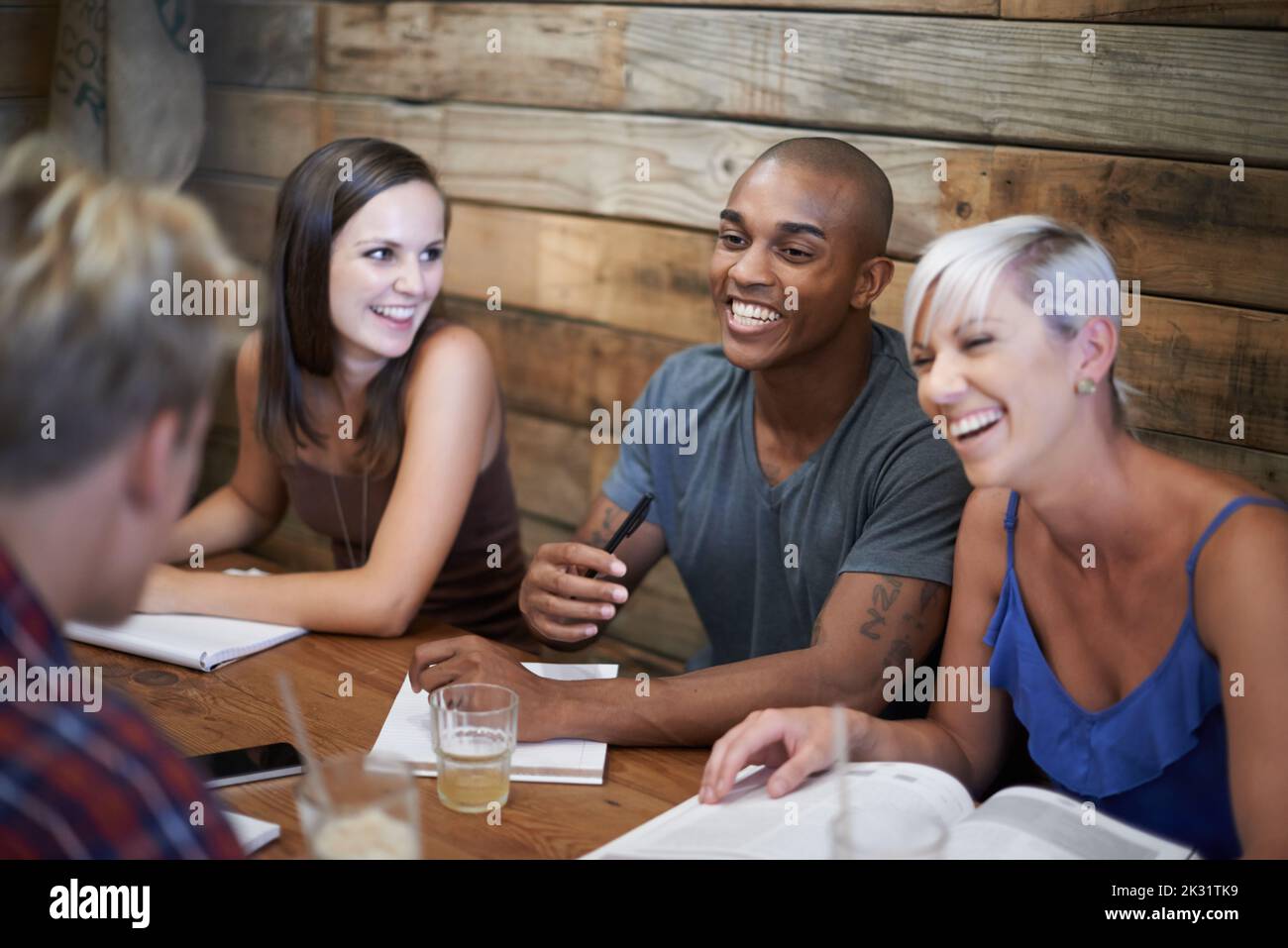 Socializing while studying. Cropped shot a group of friends studying ...