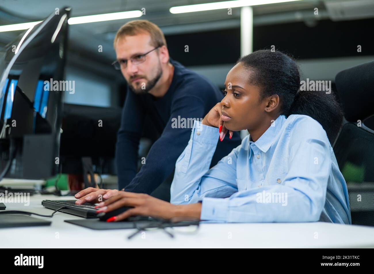 Colleagues look at the monitor and decide working moments. Caucasian ...