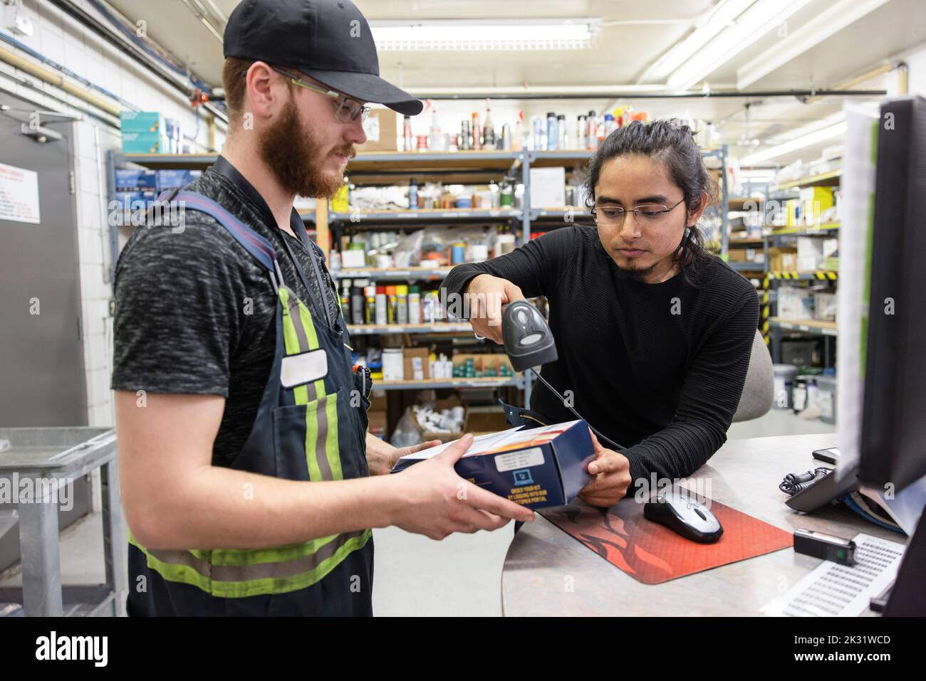 Technician scanning component in storeroom Stock Photo - Alamy