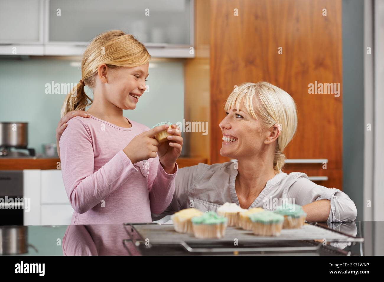 Mommy and me baking time. an attractive young woman baking with her ...