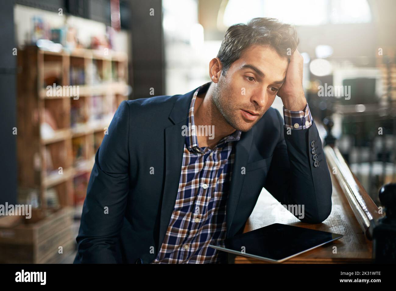 Suffering from depression. a man looking depressed while sitting at the ...