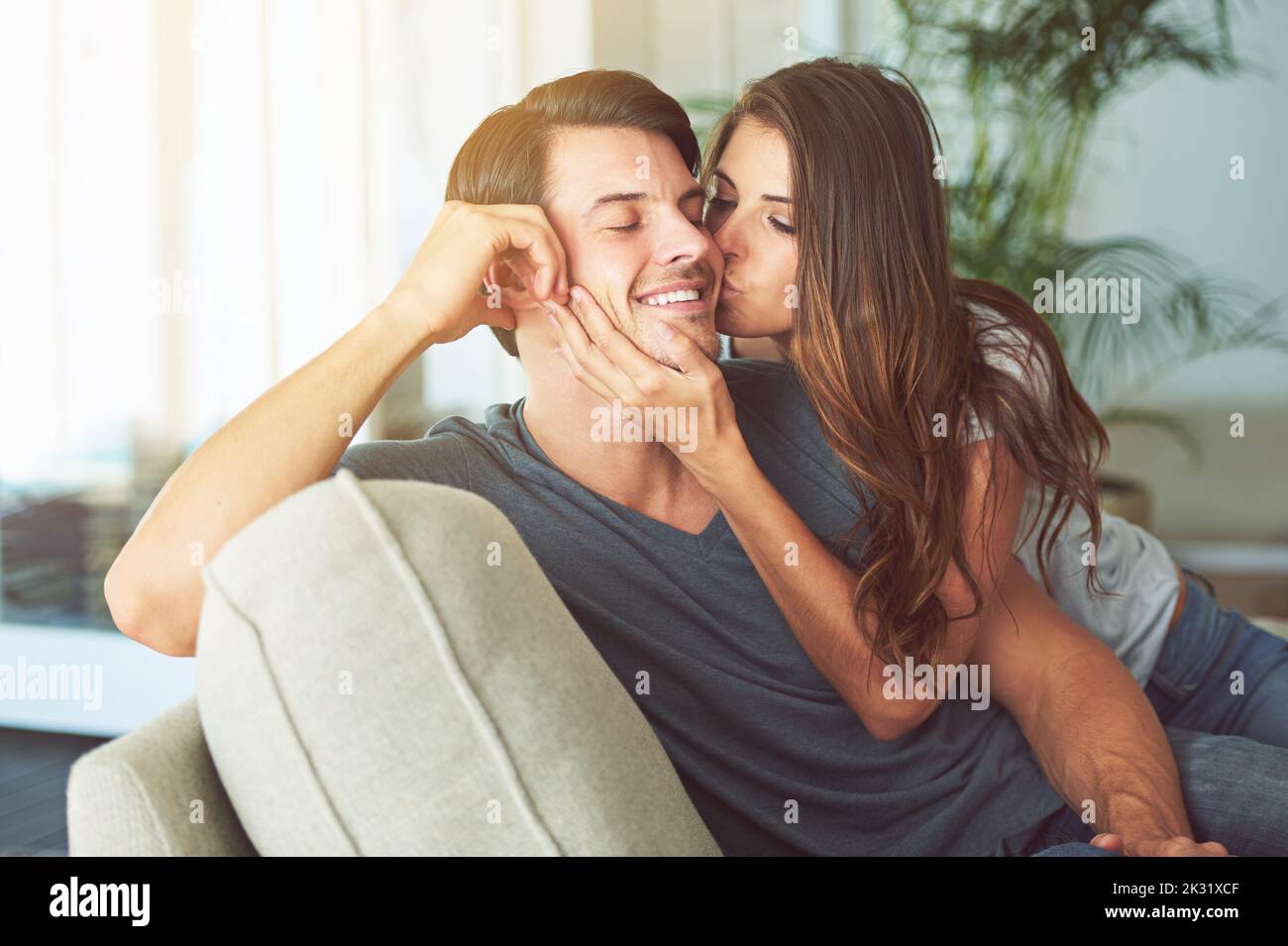 Feeling loved...an affectionate young couple enjoying their day at home ...