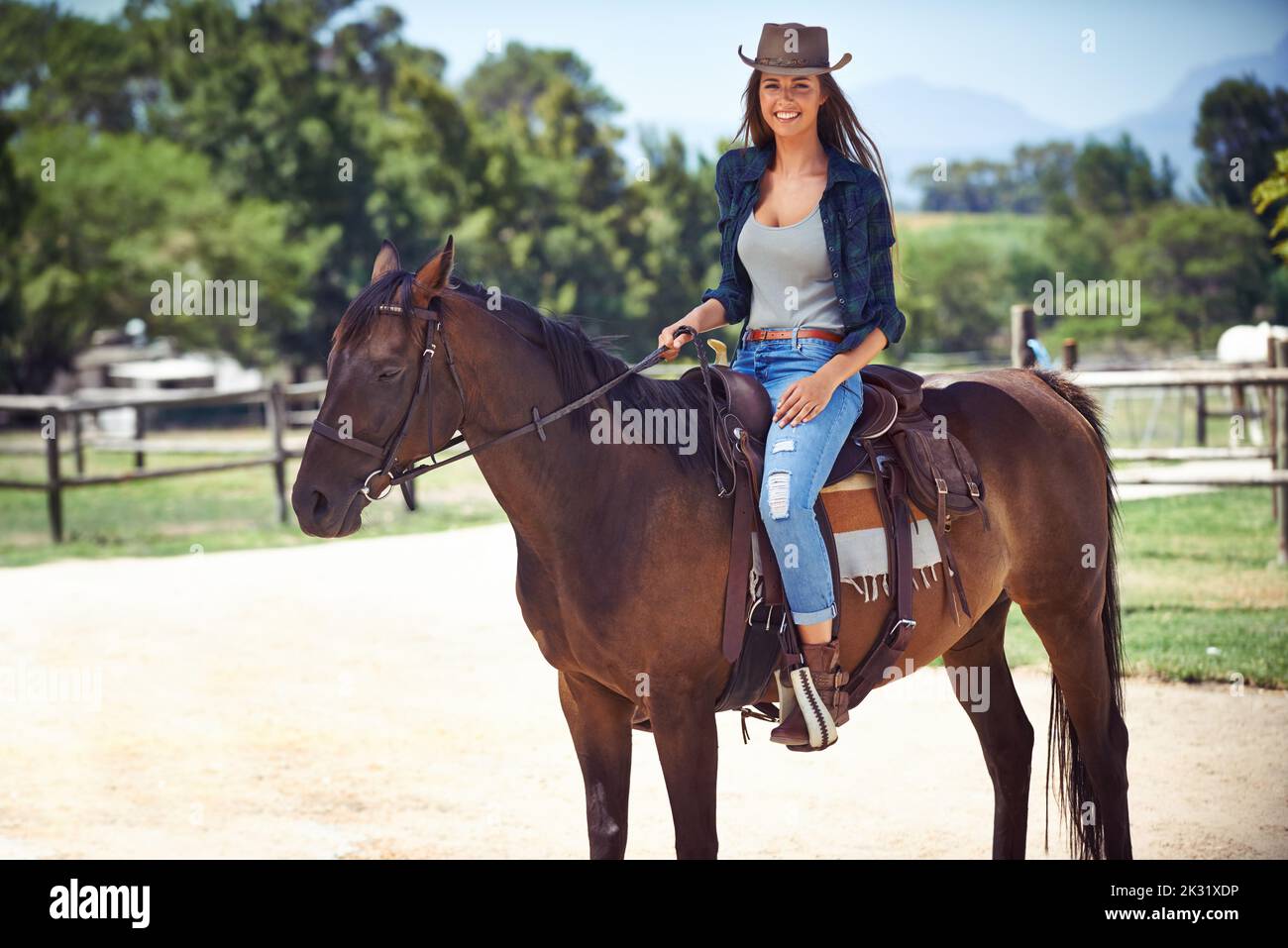 Loving the outdoors. a beautiful young woman and her horse on a ranch ...