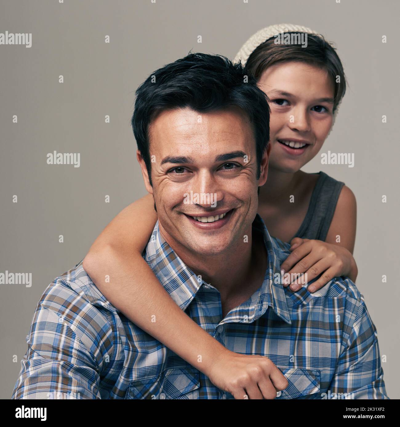 Home is where Dad is. Studio shot of a trendy father and son against a ...