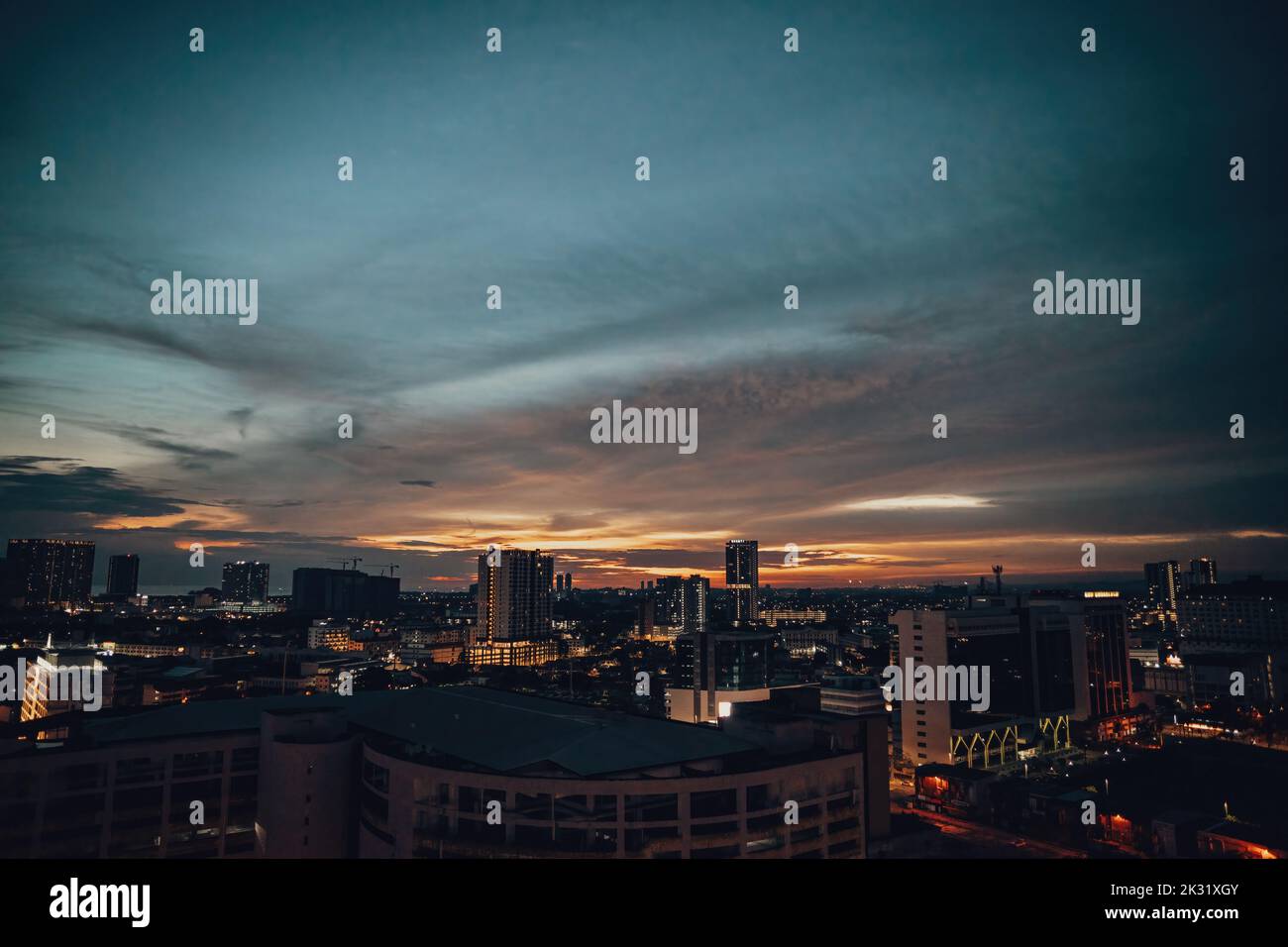 Panoramic view of city skyline, traffic and light during sunset ...