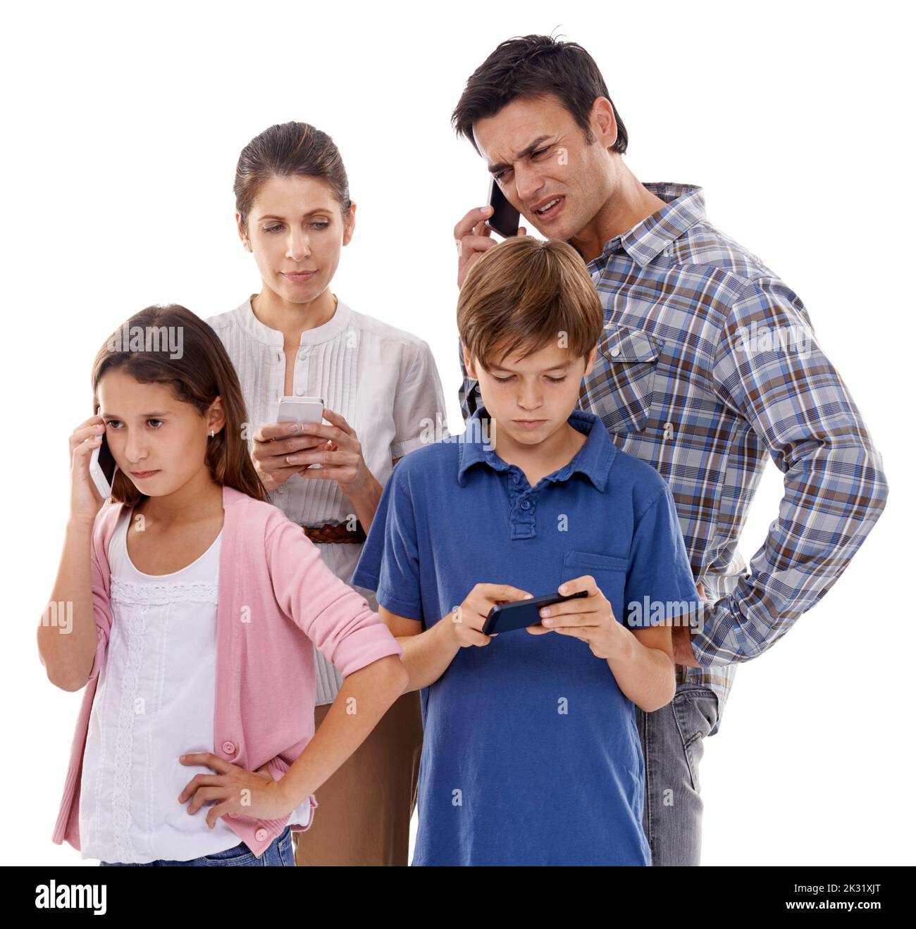 Preoccupied...Studio shot of four family members each using their ...