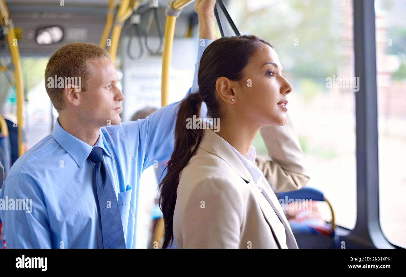 Riding the bus in style. young business people commuting to work Stock ...