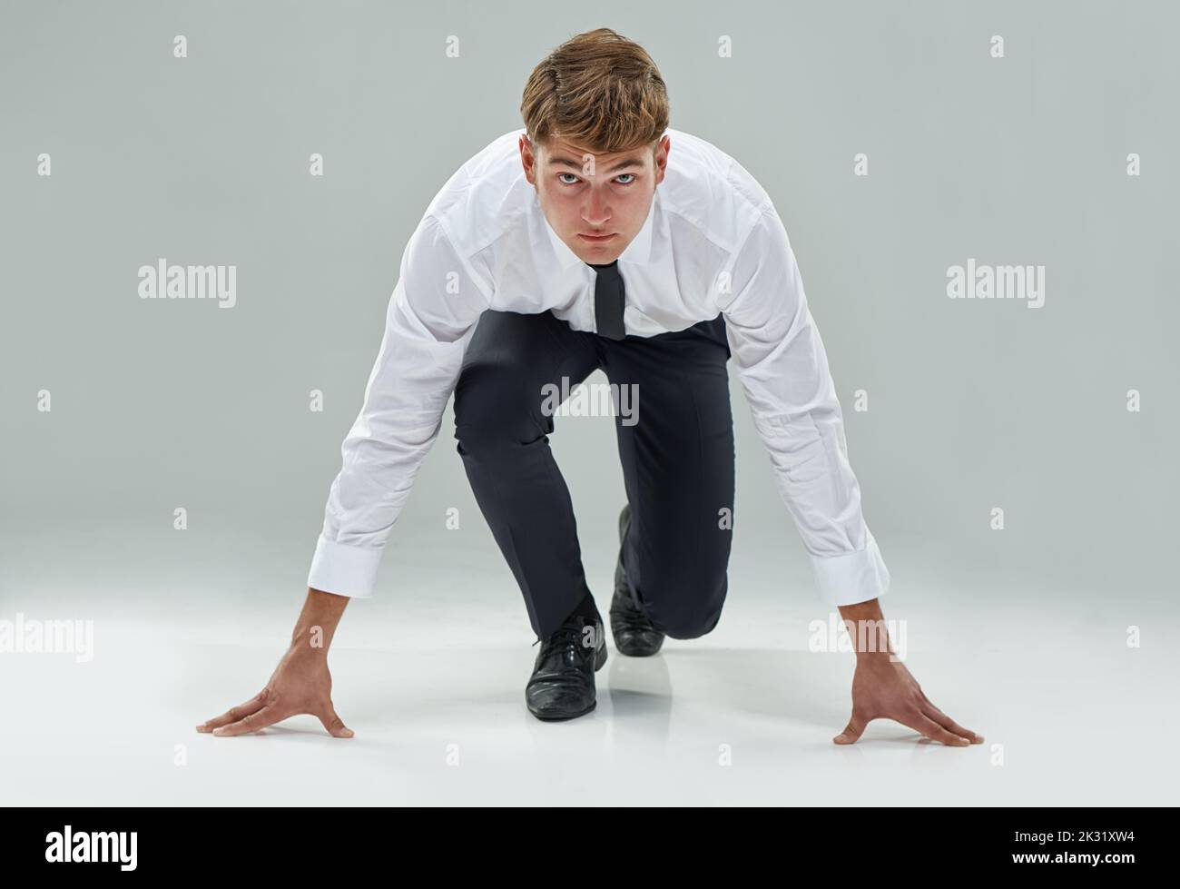 The key to success is getting a head start. A business man poised in ...