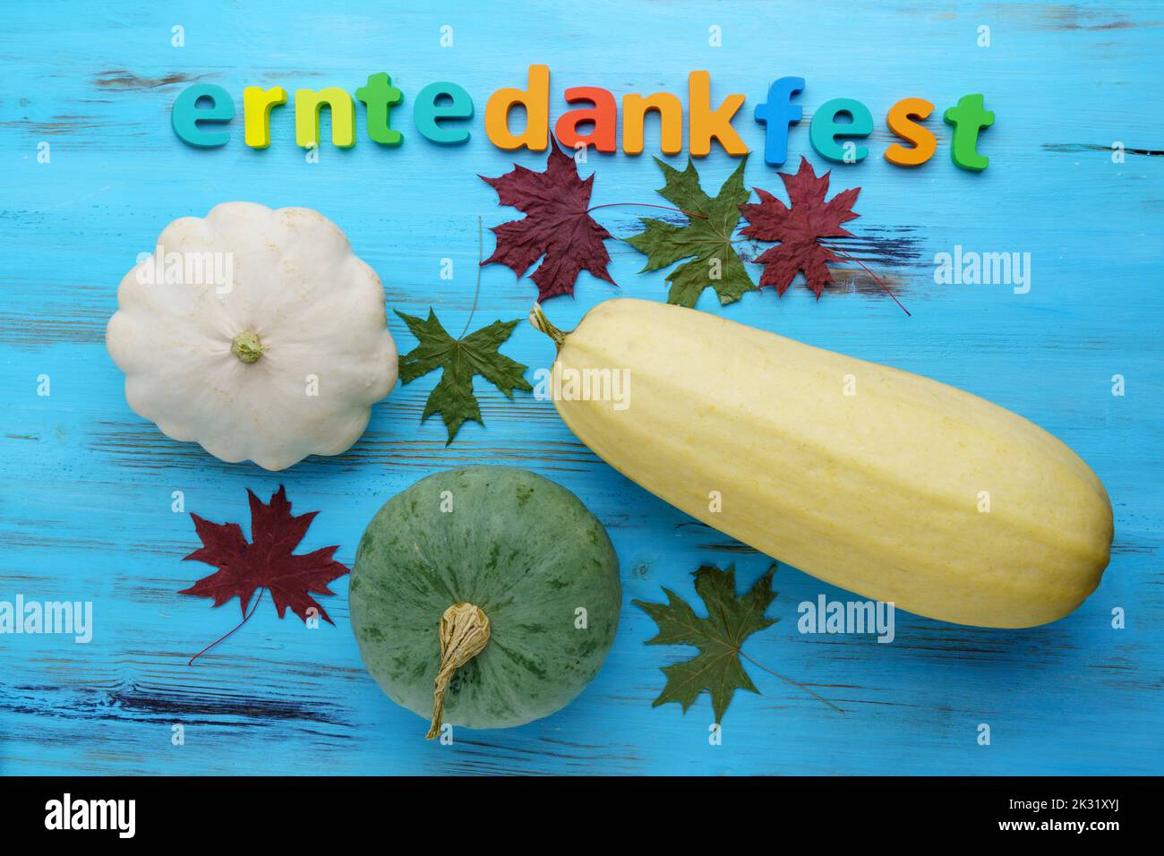 Erntedankfest harvest festival in Germany. Pumpkin, squash, wooden blue ...