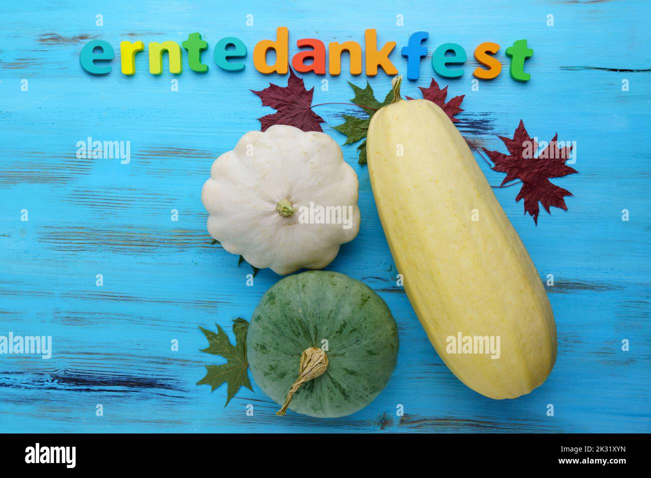 Erntedankfest harvest festival in Germany. Pumpkin, squash, wooden blue ...