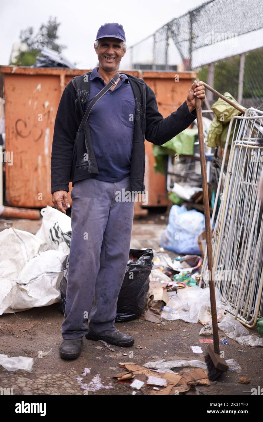 Keeping our city clean-ish. a street cleaner sweeping up garbage Stock ...