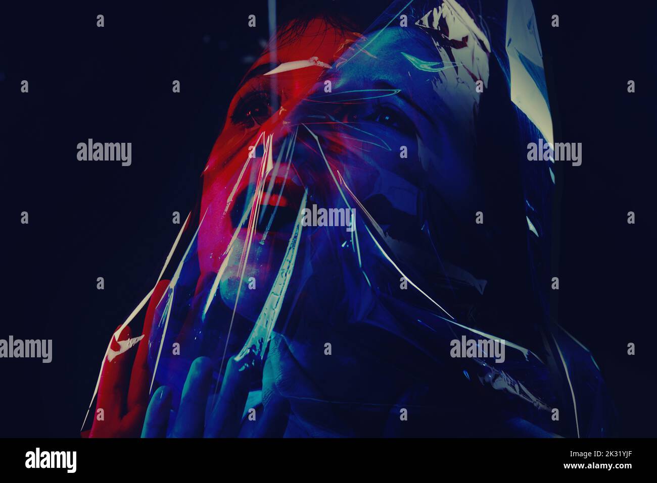 Gasping for life. A young woman suffocating with her head wrapped in ...