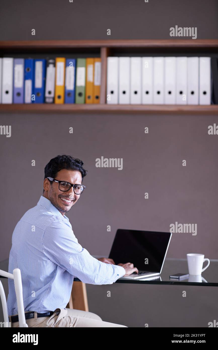 Hes working hard to complete his tasks. a handsome young businessman ...
