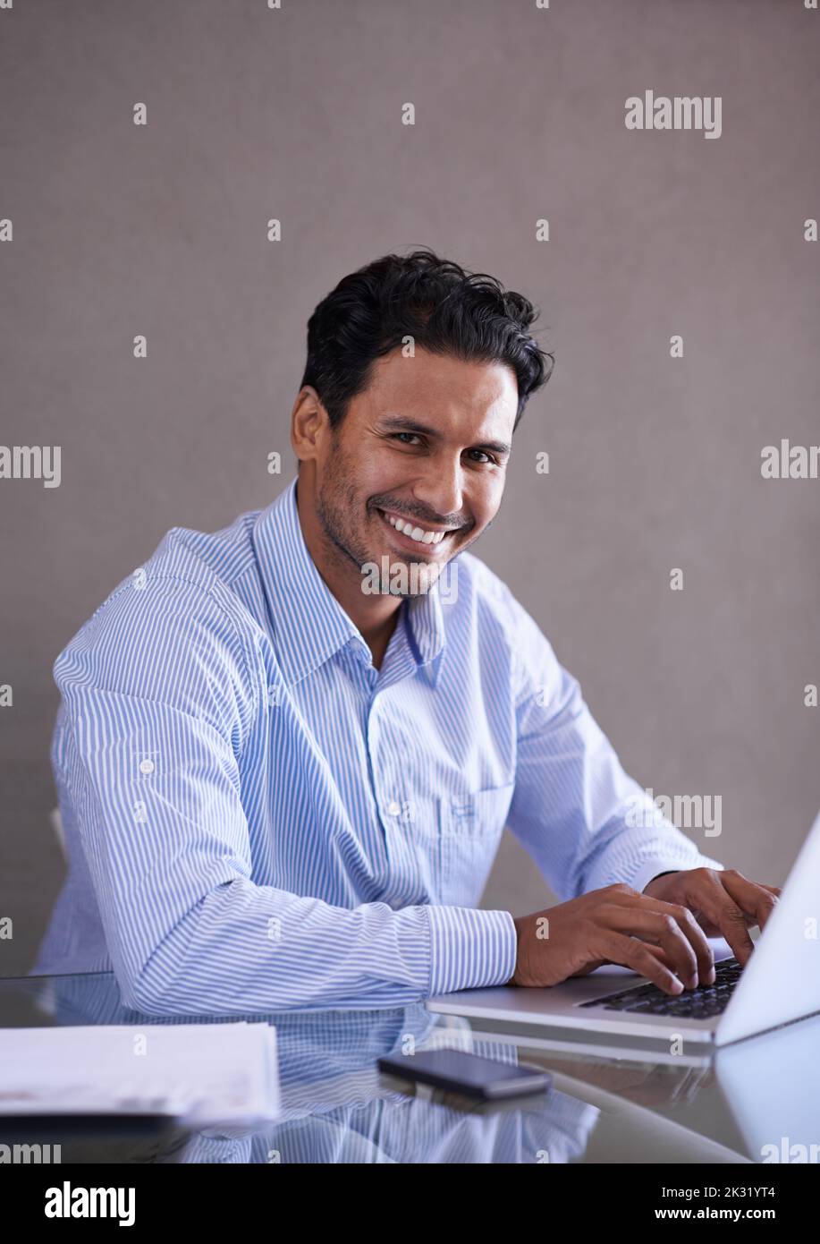 Hes working hard to complete his tasks. a handsome young businessman ...