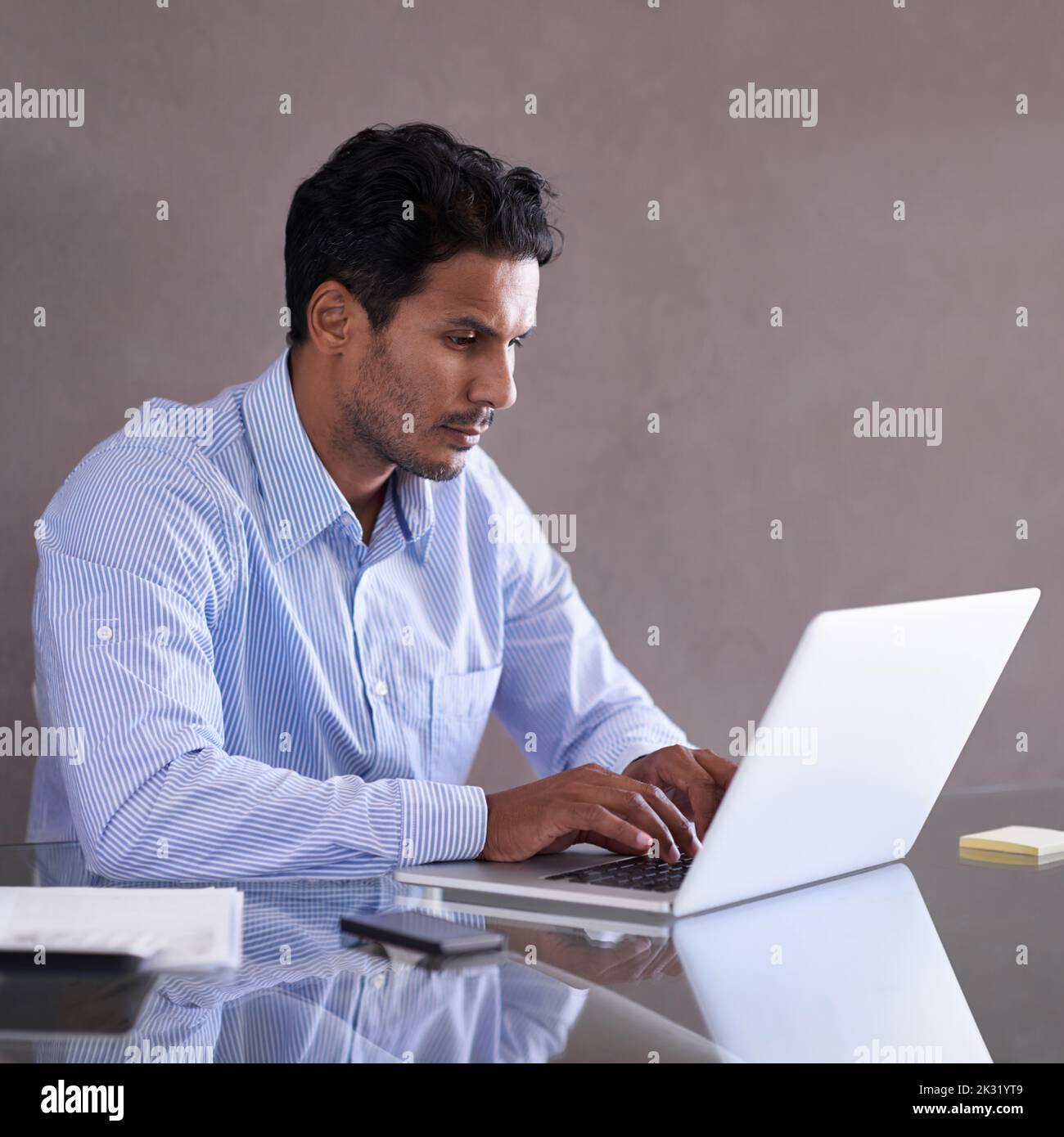 Hes working hard to complete his tasks. a handsome young businessman ...