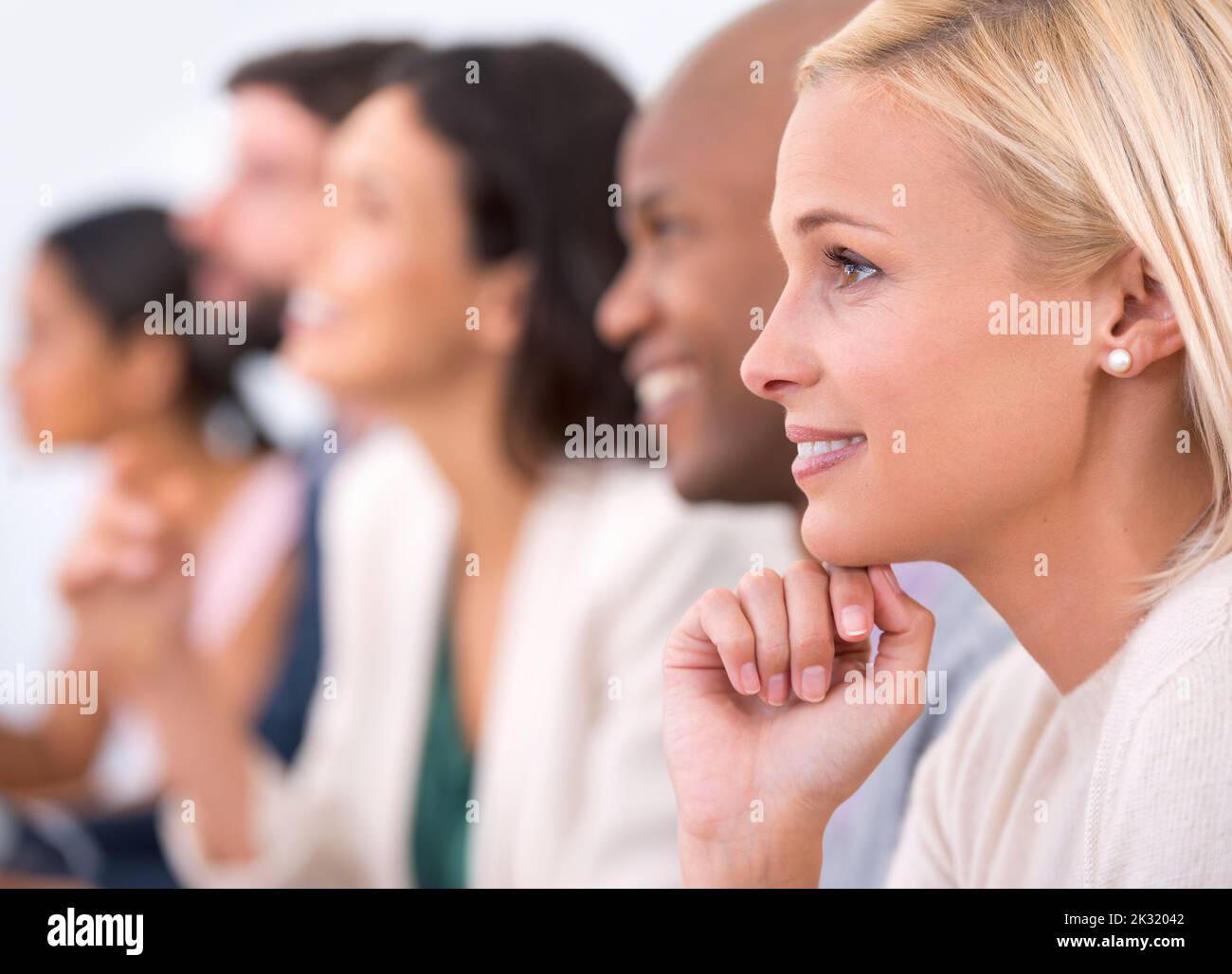 Content business team. A group of business people sitting in a row ...