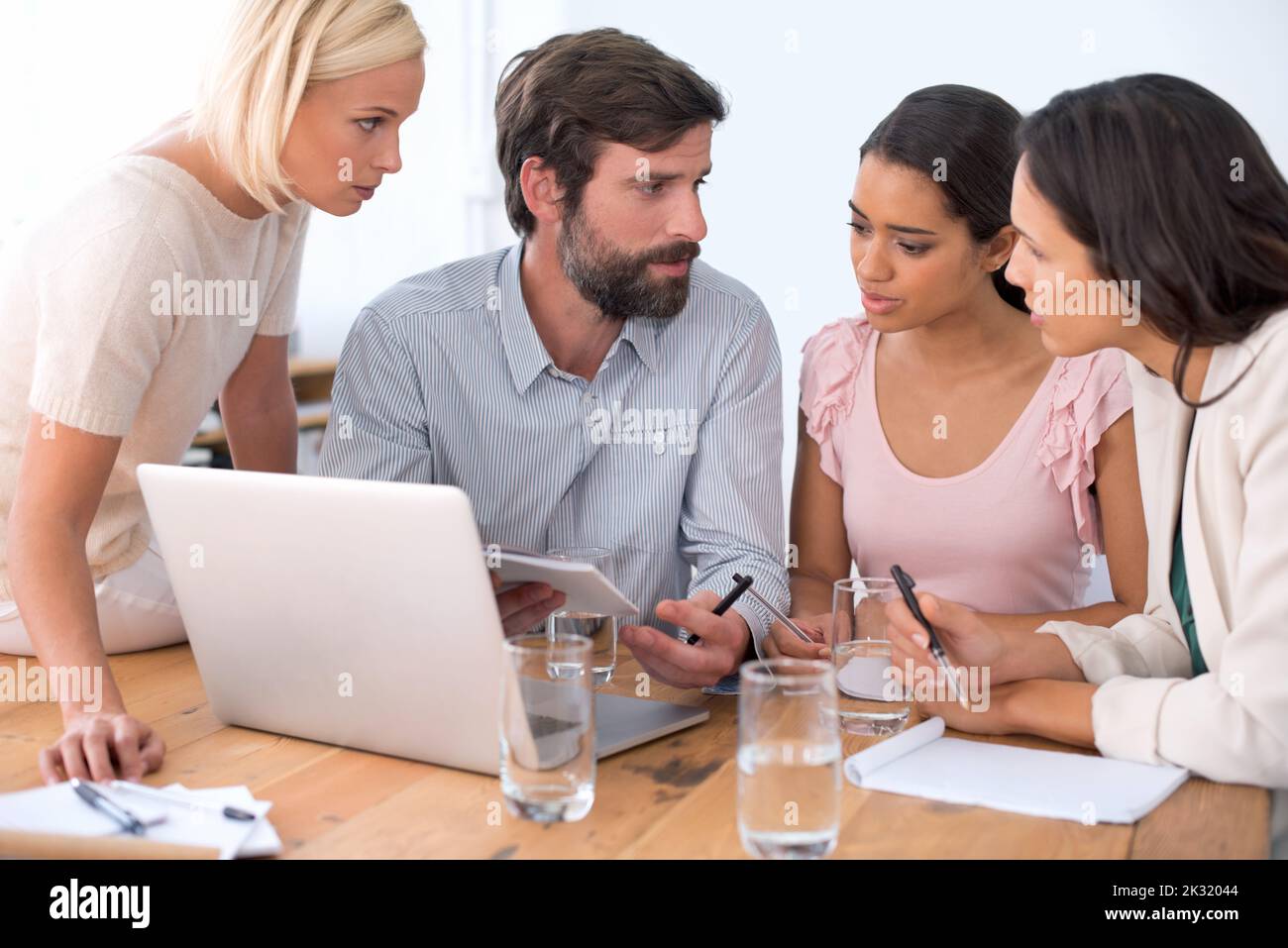 Business conversations. a group of business people in the middle of a ...