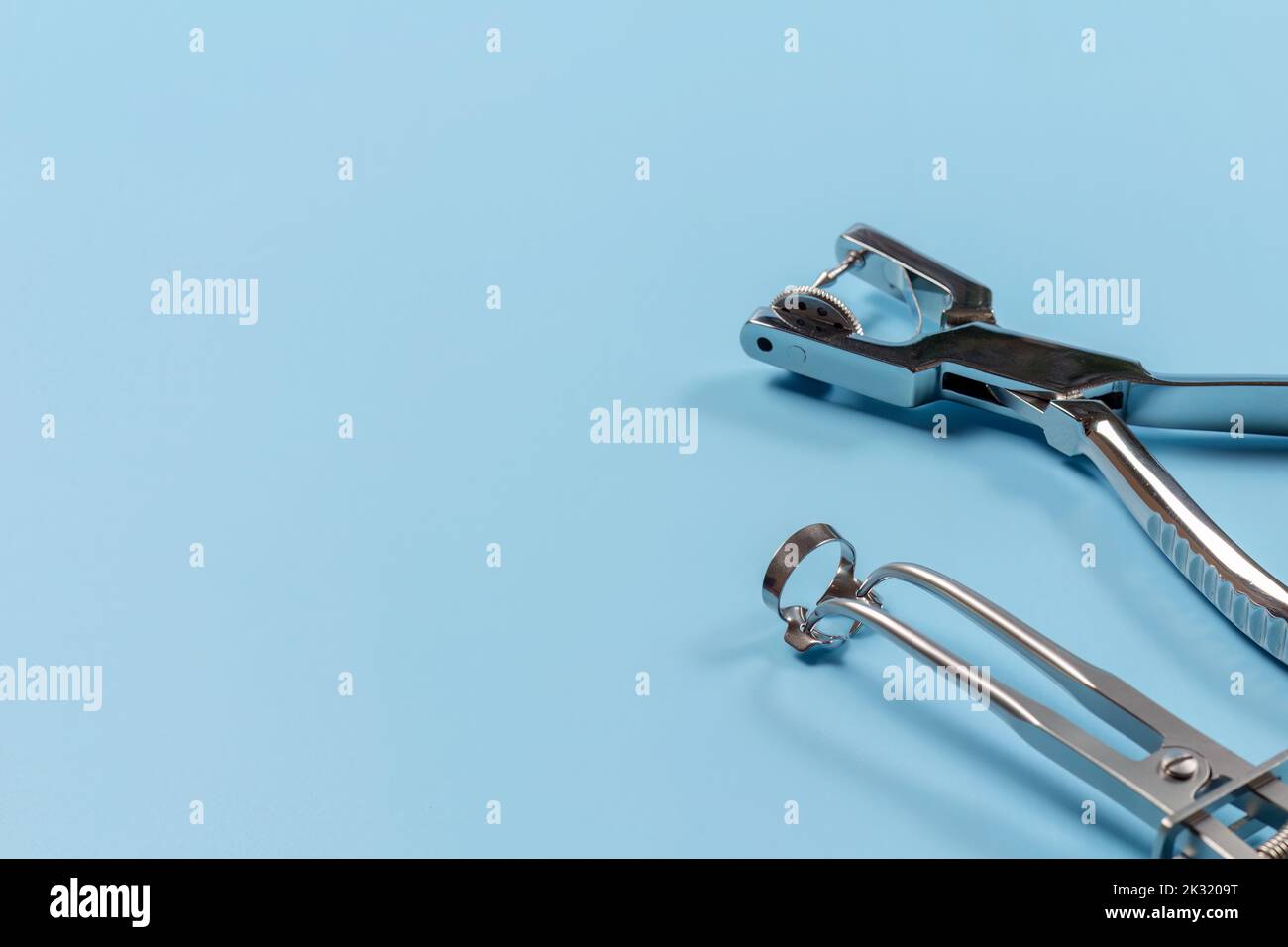 Dental hole punch, metal clamp and rubber dam forceps Stock Photo - Alamy