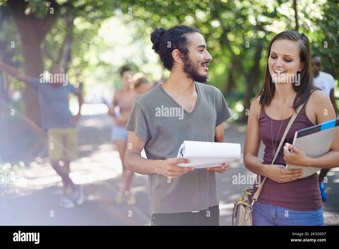 Chatting in between classes. a male and female student chatting on ...